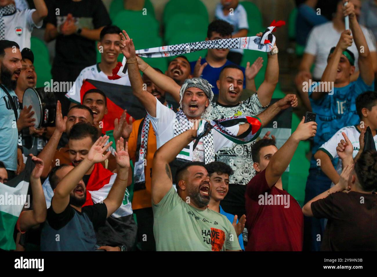 Iraqi soccer fans cheer for their team during the Asian qualifier group ...
