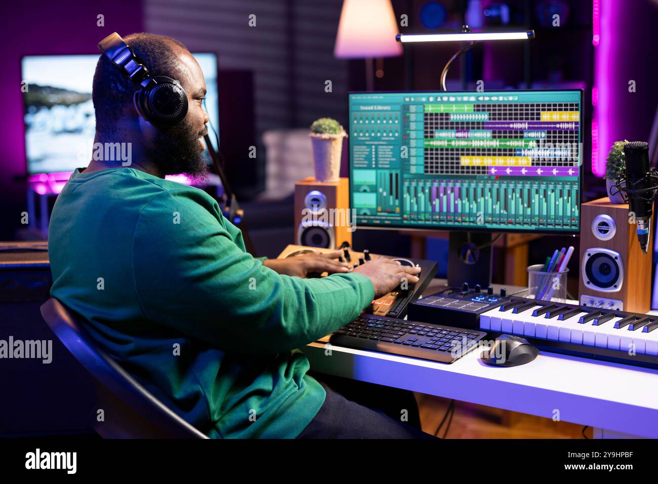 Young musician twisting knobs mixing hi-res stock photography and ...