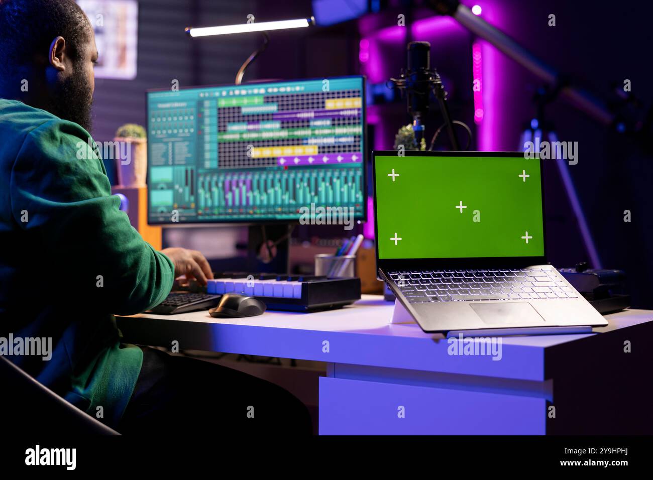 Professional artist operating on daw software in home studio, using a ...