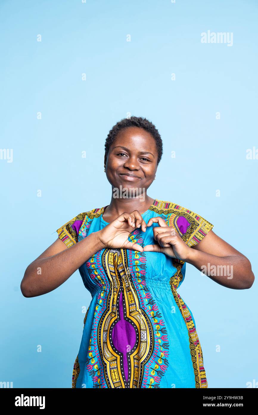 Female model showing heart shape symbol in front of camera, presenting ...