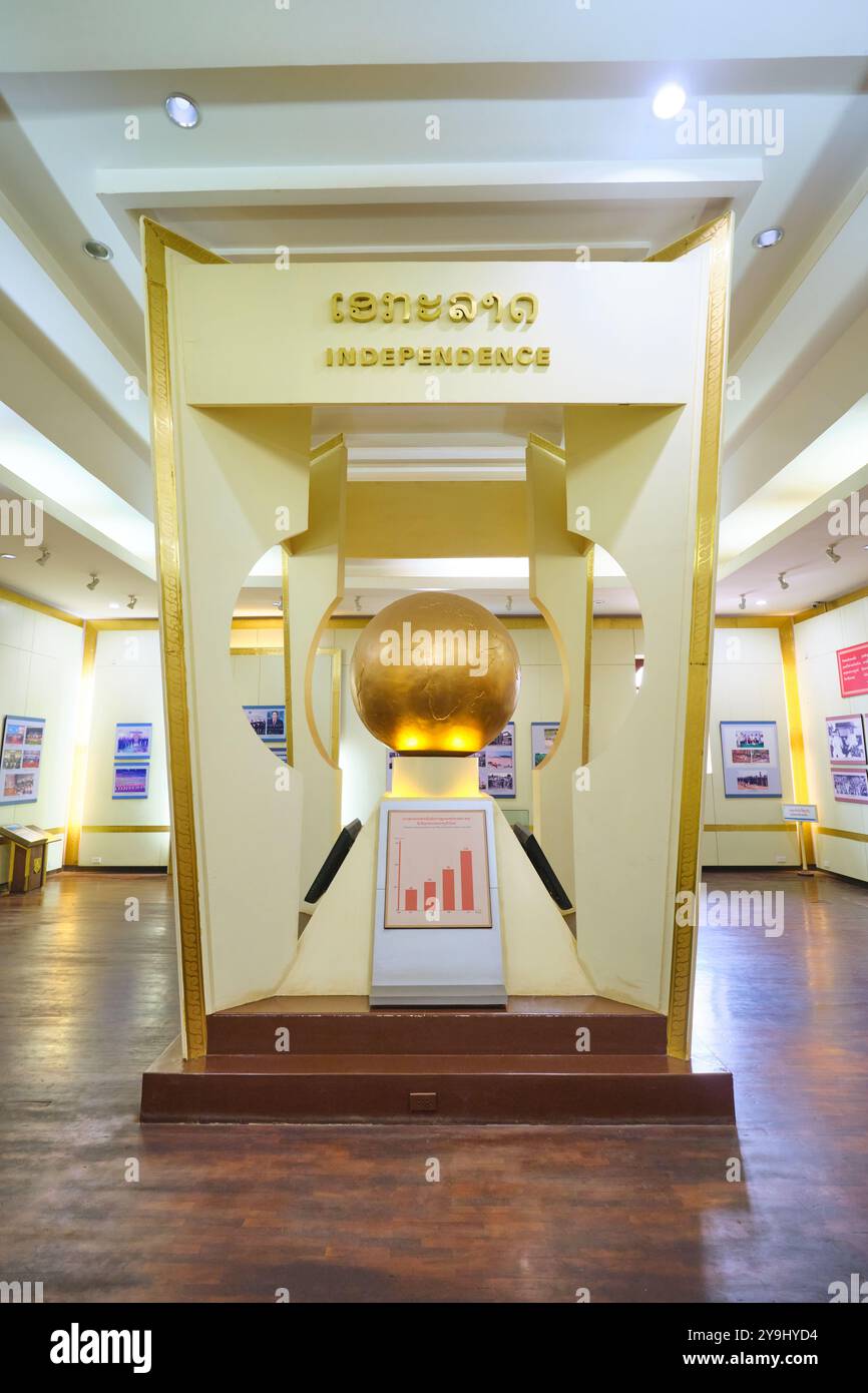 A gallery featuring a large, gold sphere, a monument to independence ...