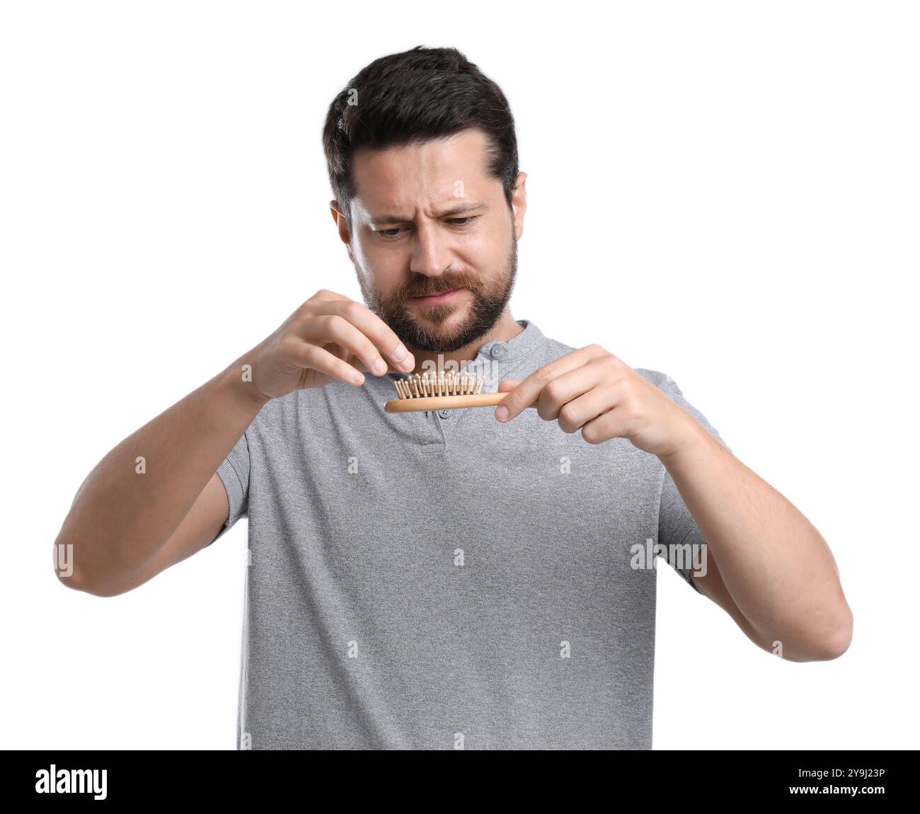 Sad man taking his lost hair from brush on white background. Alopecia ...