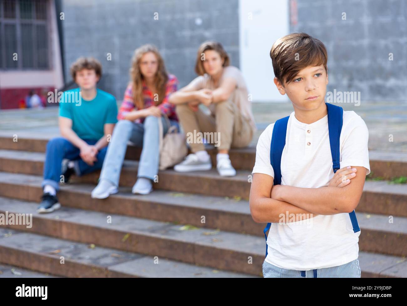 Sad school boy and bullies Stock Photo - Alamy