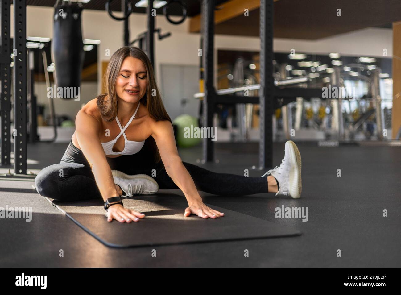 Athletic fitness woman stretching body at gym enjoy physical exercise ...