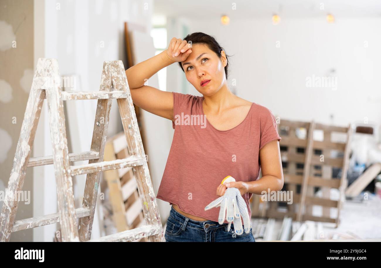 Portrait of tired woman in apartment during repair works Stock Photo ...