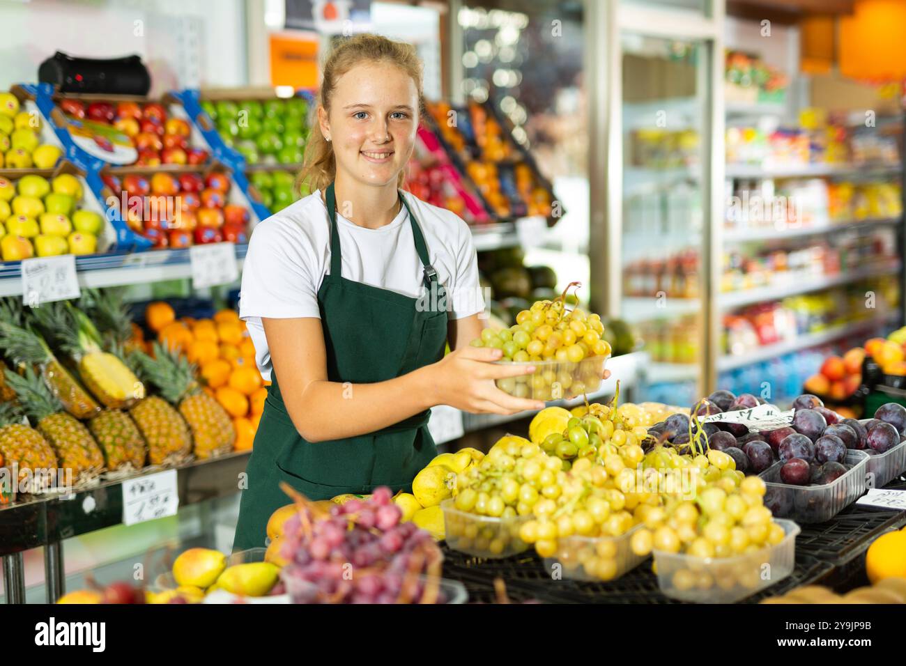 Teenage girl working in grocery as job experience Stock Photo - Alamy