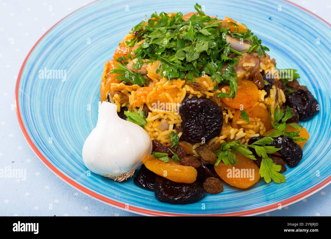 Lamb pilau with dried fruits and greens Stock Photo - Alamy