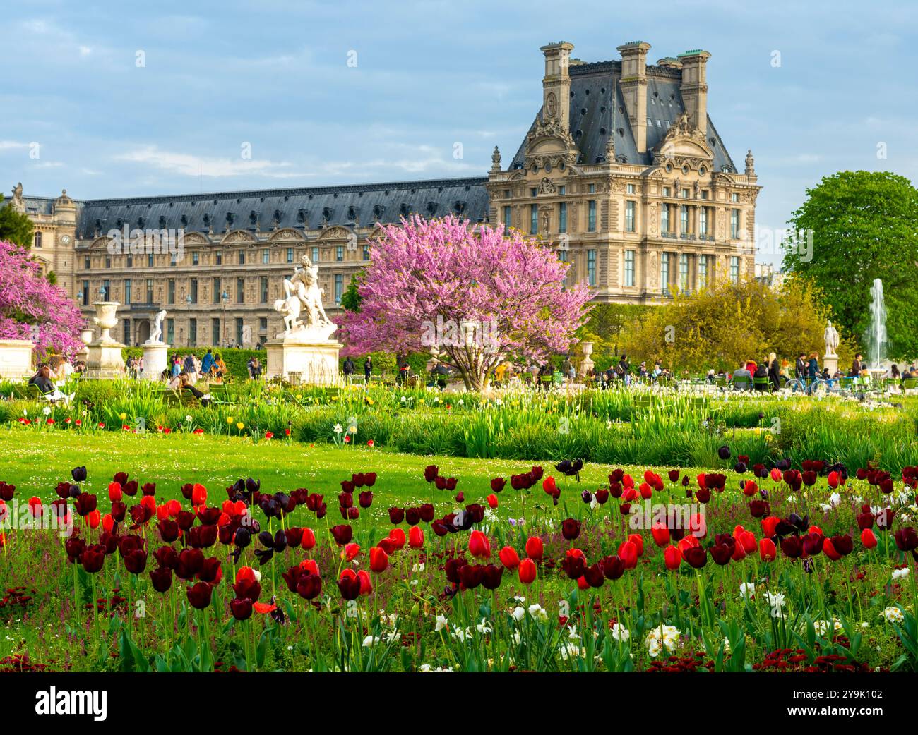 Scene from the Tuileries Gardens with flowers in the foreground ...