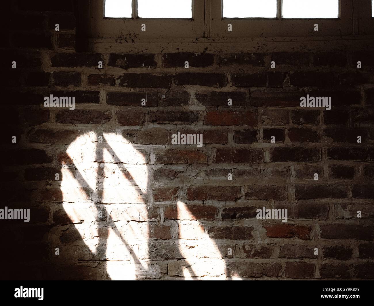 light through window on brick wall Stock Photo - Alamy
