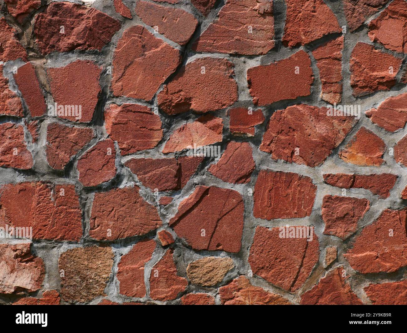 Explore the Unique Texture of a Red Natural Stone Wall Featuring Rich ...