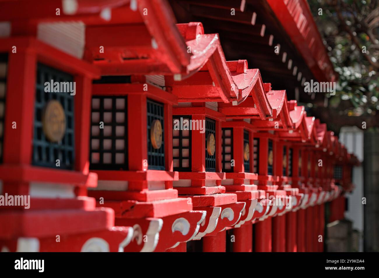 A line of traditional red Tourou lanterns line the outer wall of a ...