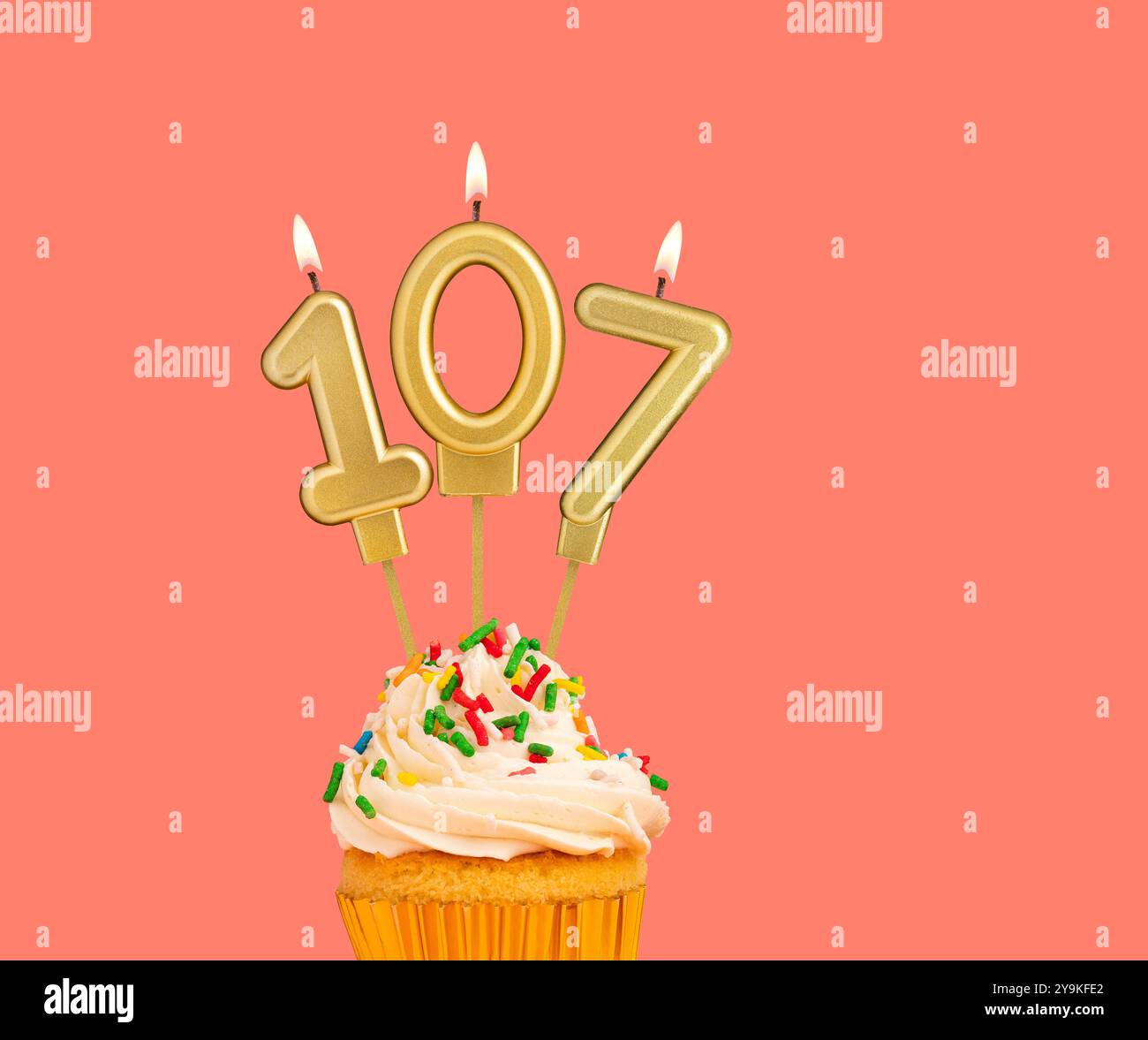 Birthday number 107 - Golden candle with cupcake Stock Photo - Alamy
