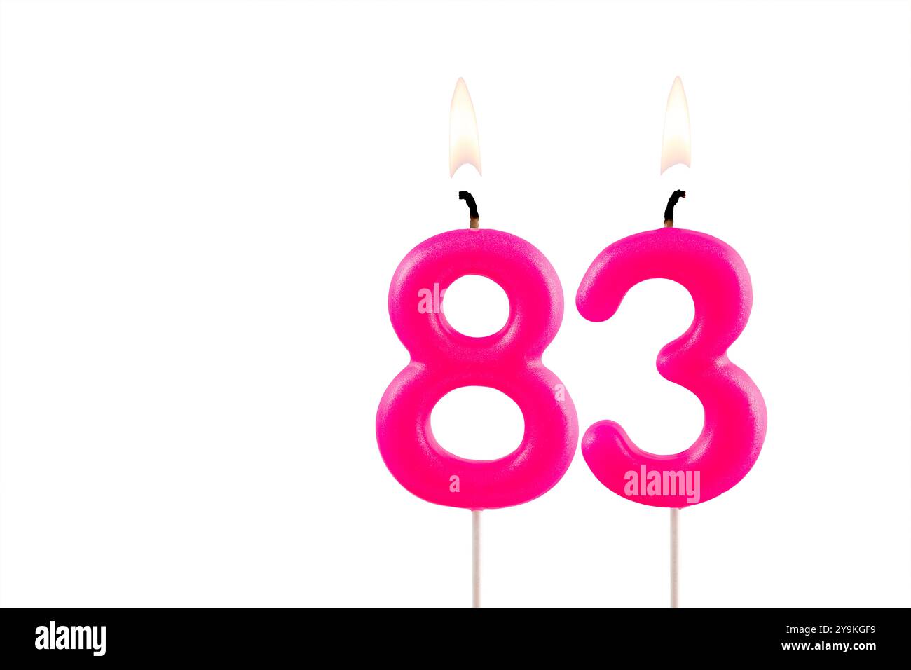 Pink number 83 birthday candle on white background Stock Photo - Alamy