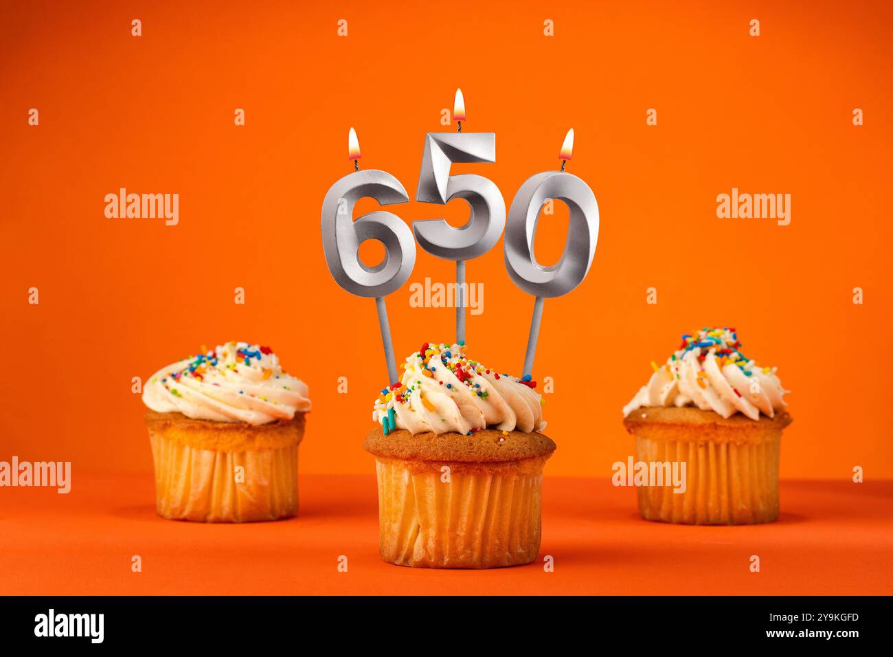 Birthday celebration in orange color - Candle number 650 Stock Photo ...
