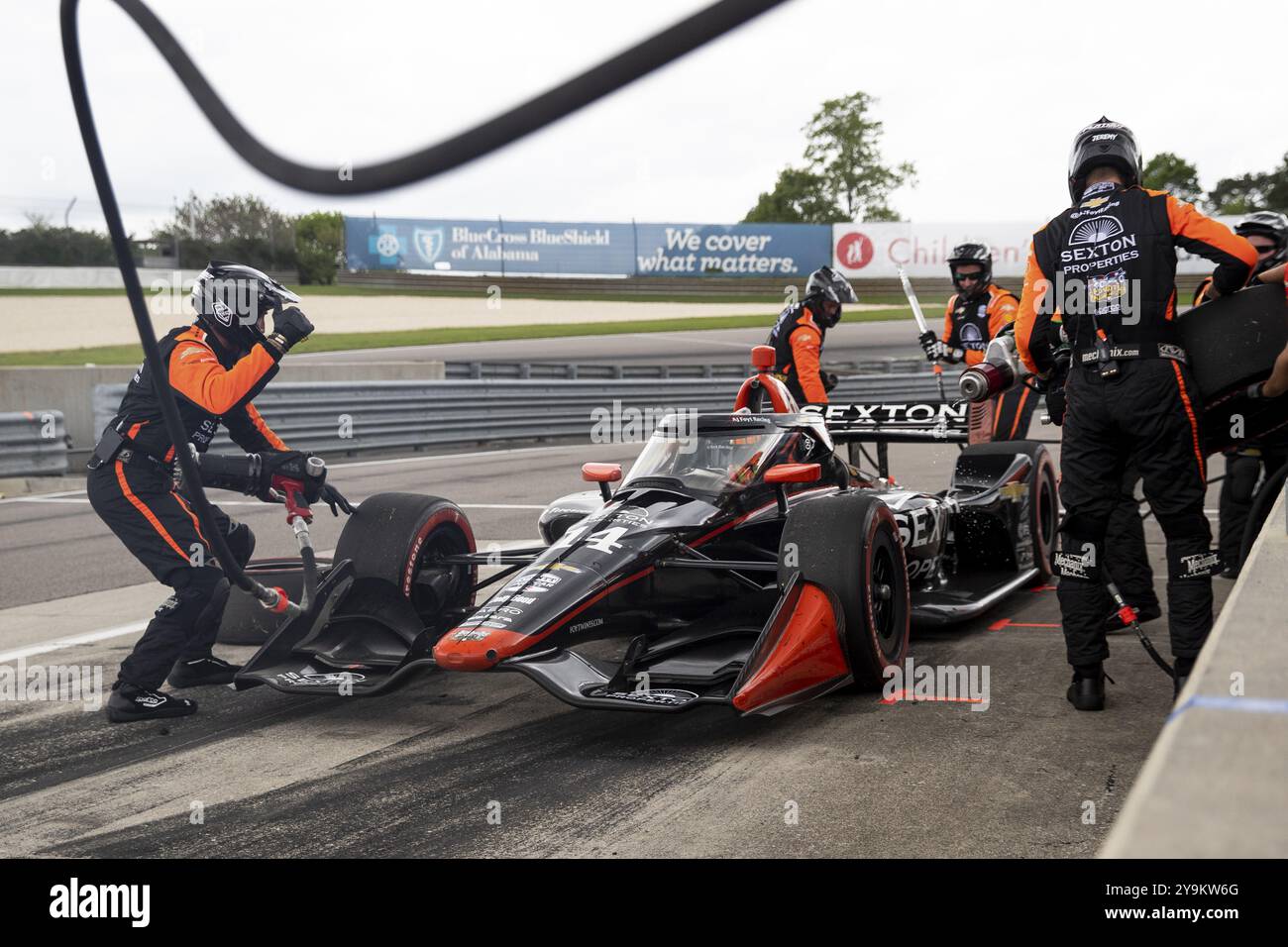 The crew of AJ Foyt Racing perform a pit stop during the Children's of ...