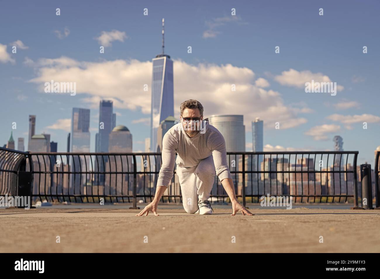 Sport runner at the start. Sprinter leaving starting on running track ...