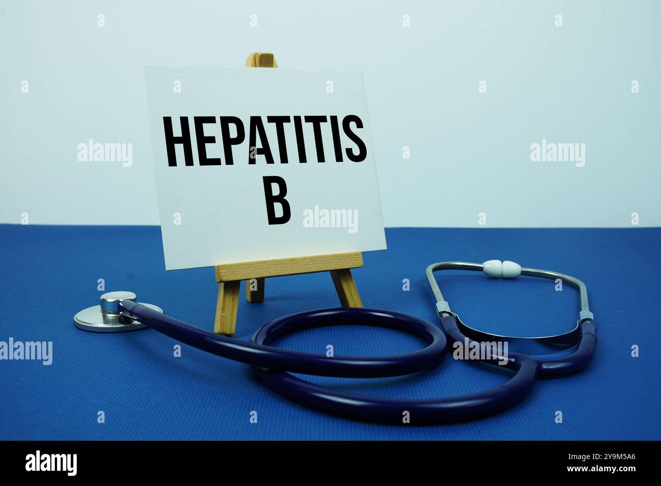 Hepatitis B text message on paper card with stethoscope on blue ...