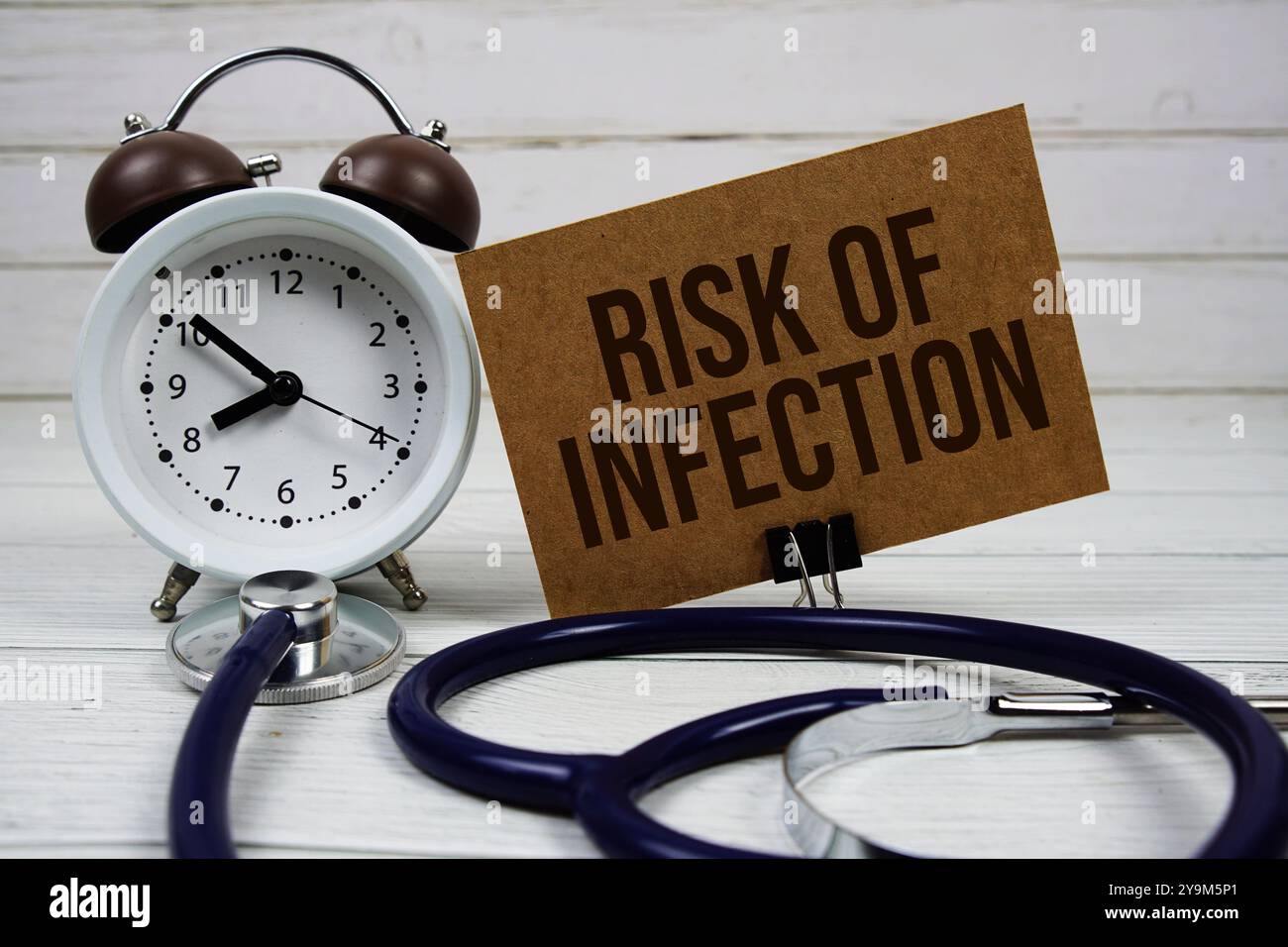 Risk Of Infection text message on paper card with stethoscope and alarm ...