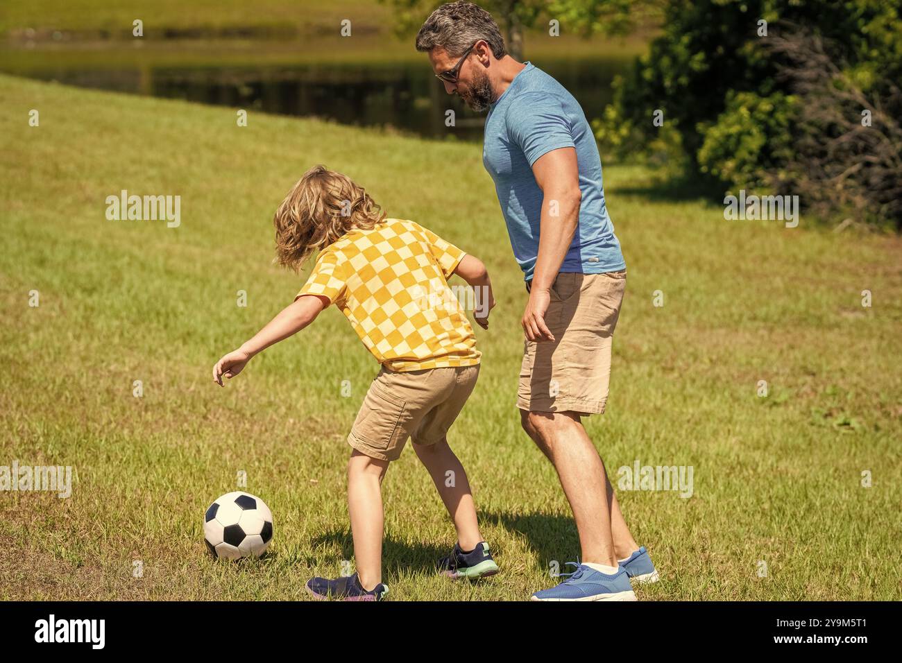 Outdoor adventures of daddy and son fatherhood together. football ...