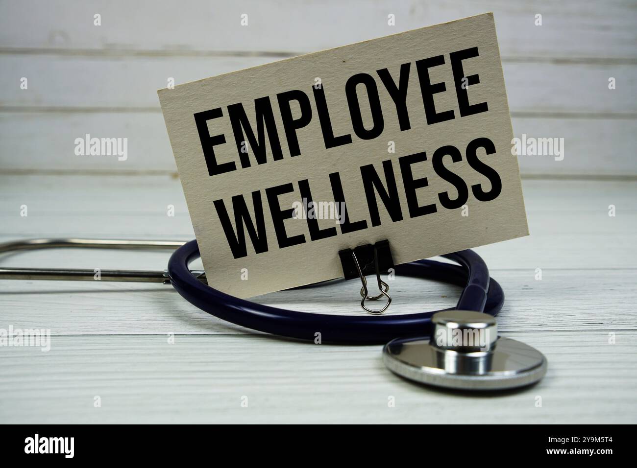 Employee Wellness Program text message on paper card with stethoscope ...