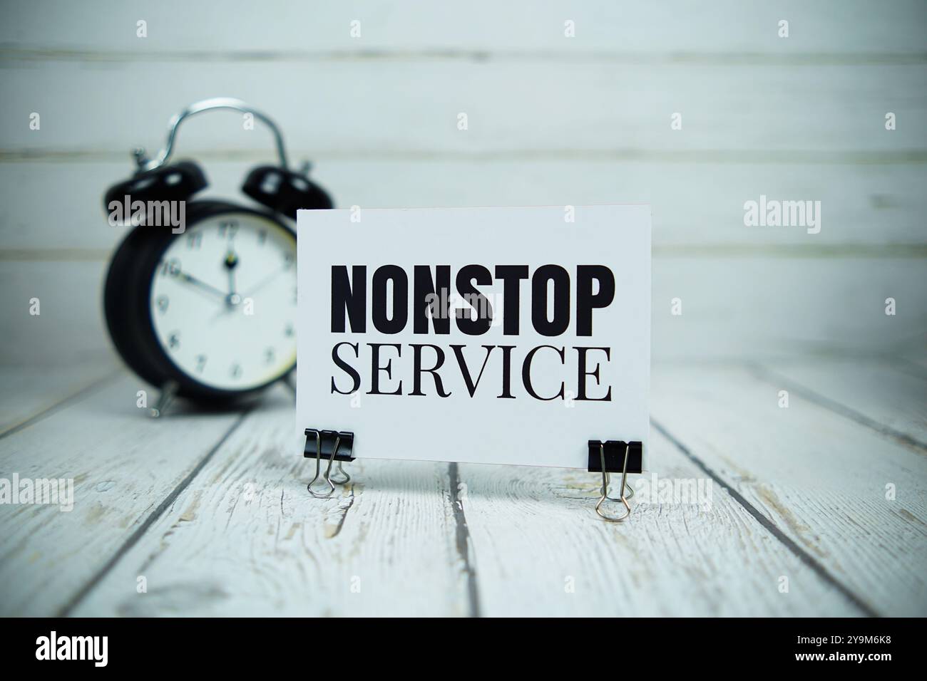 Nonstop Service text message on paper card Stock Photo - Alamy
