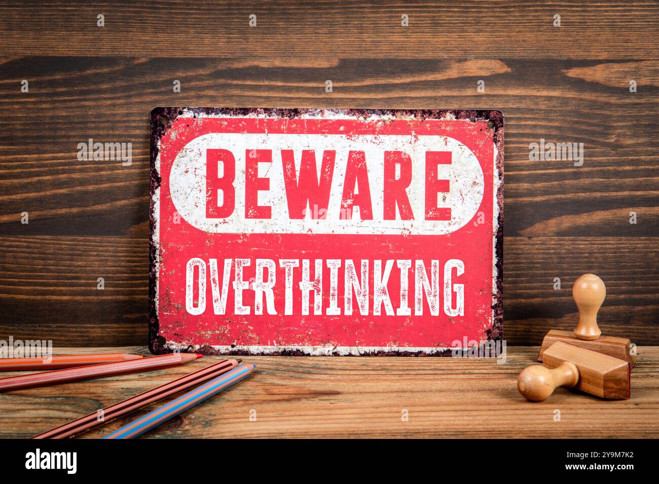 Overthinking. Beware sign with text on a wooden texture office table ...