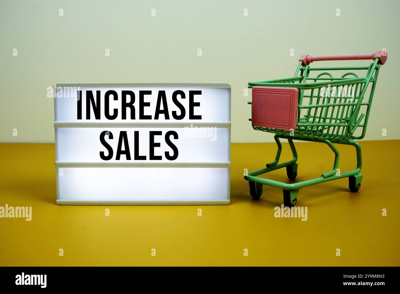 Increase Sales text on LED lightbox with trolley shopping cart on ...