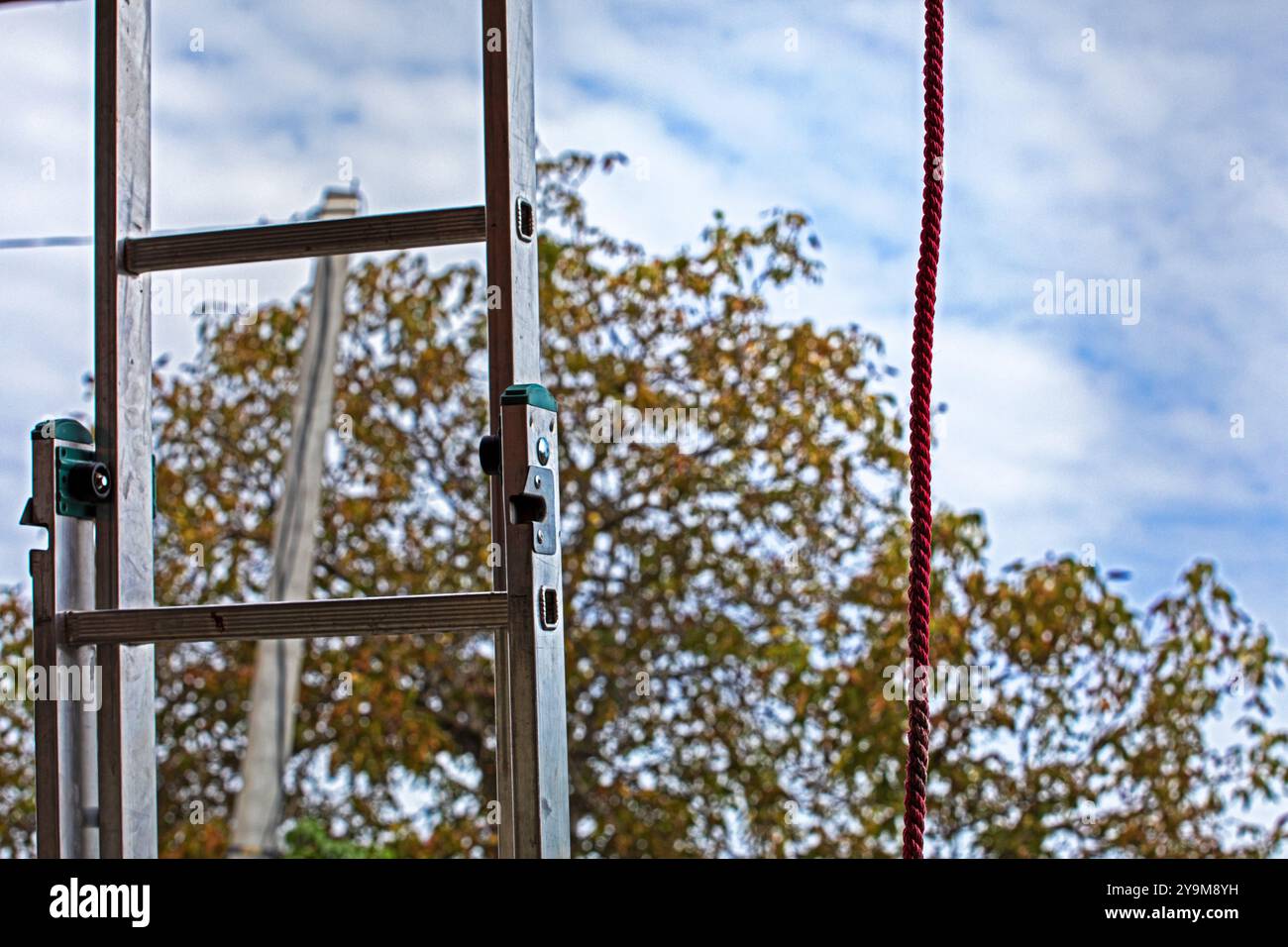 strong rope and ladder against the sky with clouds. Construction work ...
