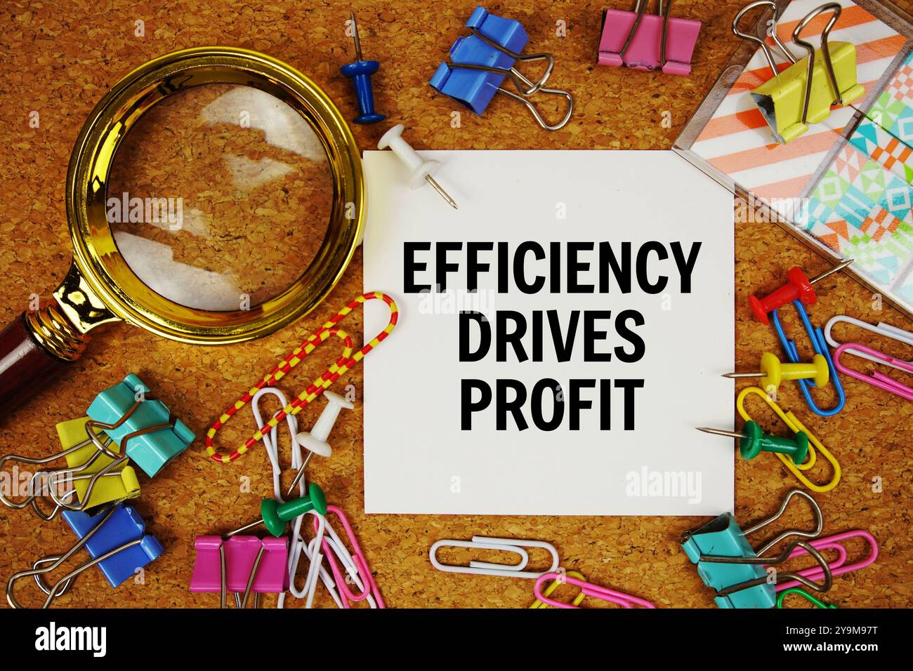 Efficiency Drives Profit text on paper card with magnifying glass and ...
