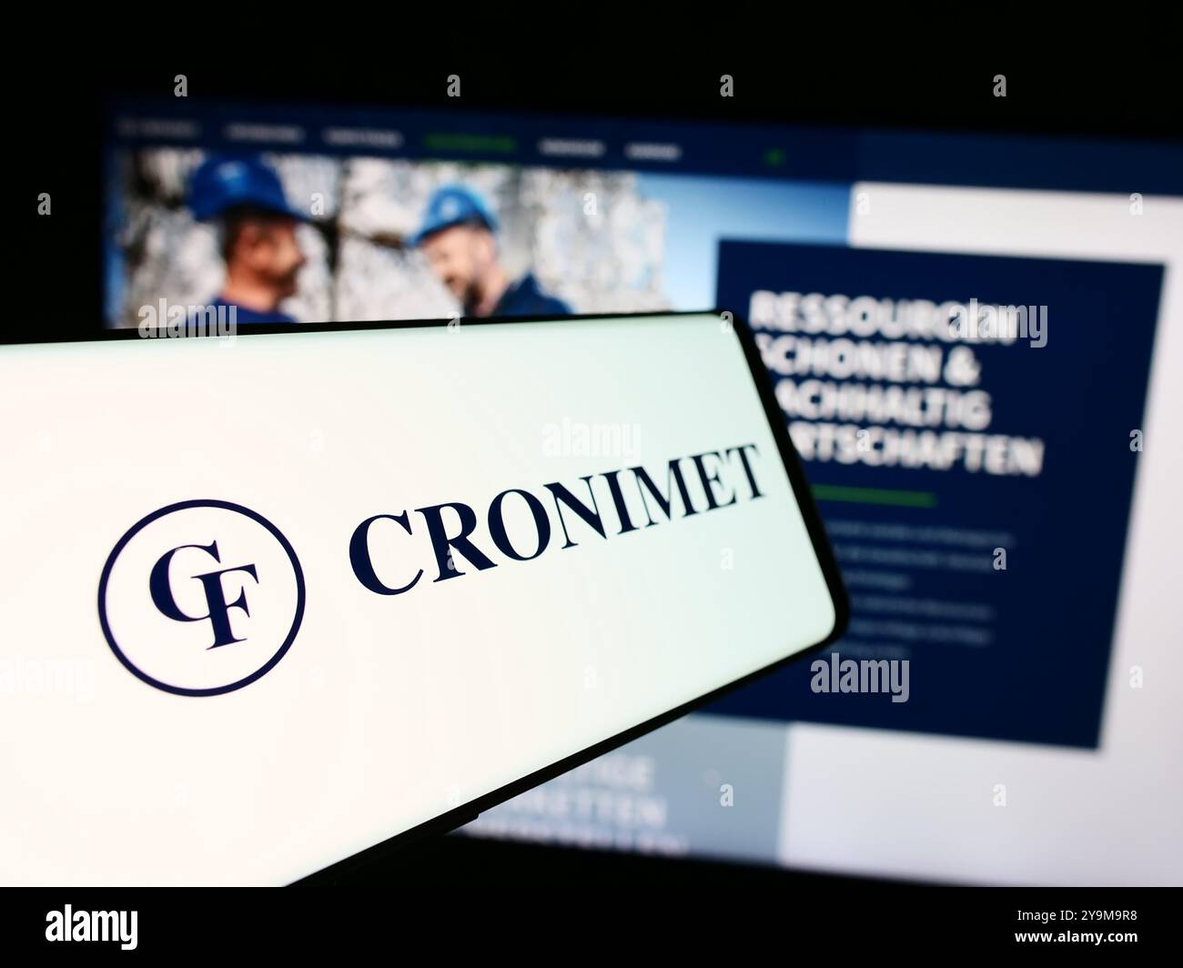 In this photo illustration, a mobile phone with the logo of German metal recycling company ...