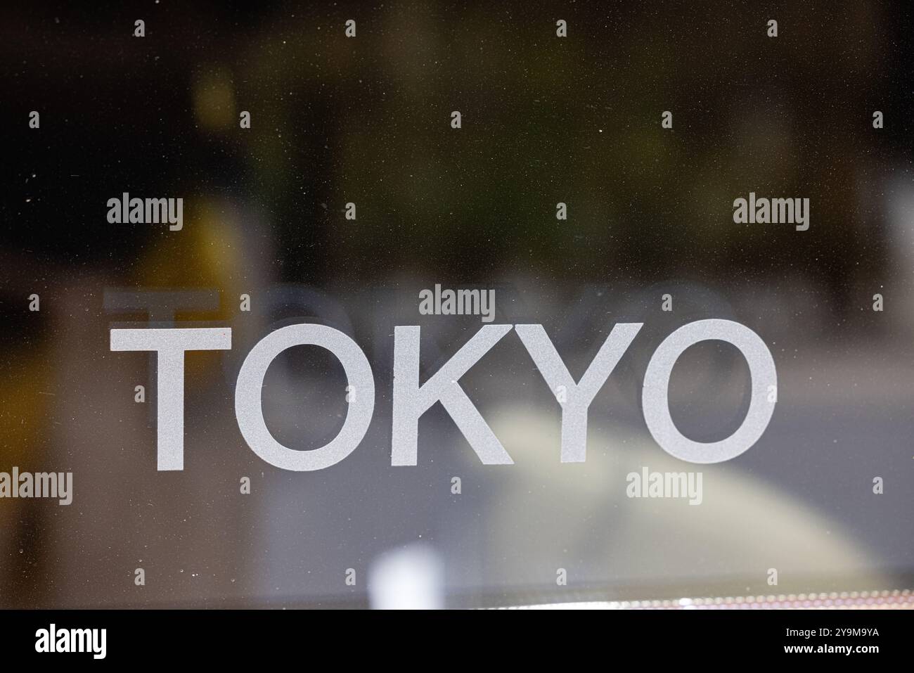 word Tokyo printed on transparent glass on the streets of Tokyo Stock ...