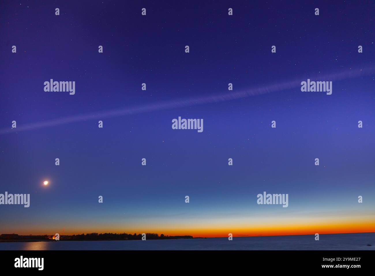 Night clear sky view with starts and late sunset on horizon, sea shore ...