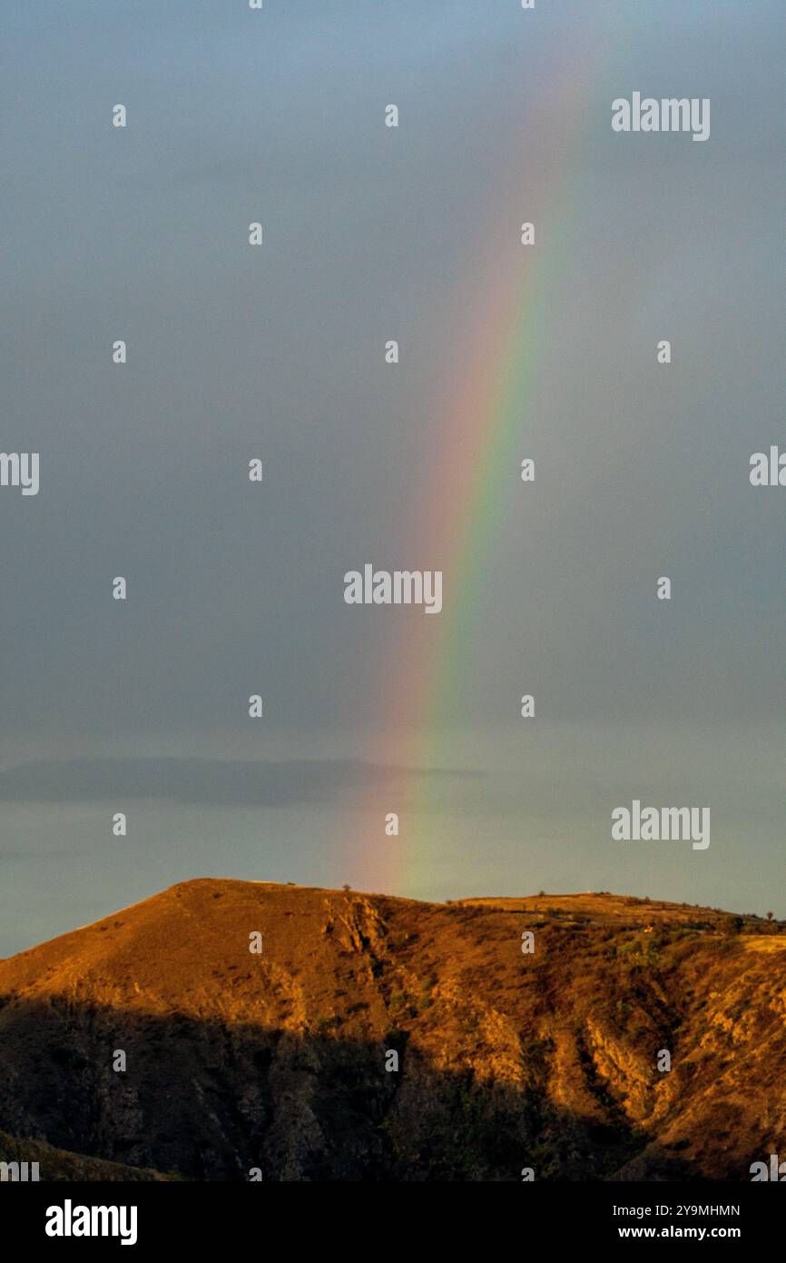Rainbow Over the Hill: A Gentle Touch After the Rain Stock Photo - Alamy