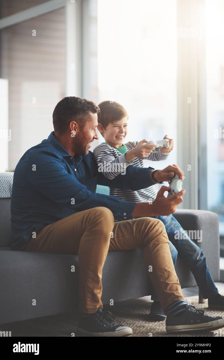 Happy, man and child with controller on sofa at home for entertainment ...