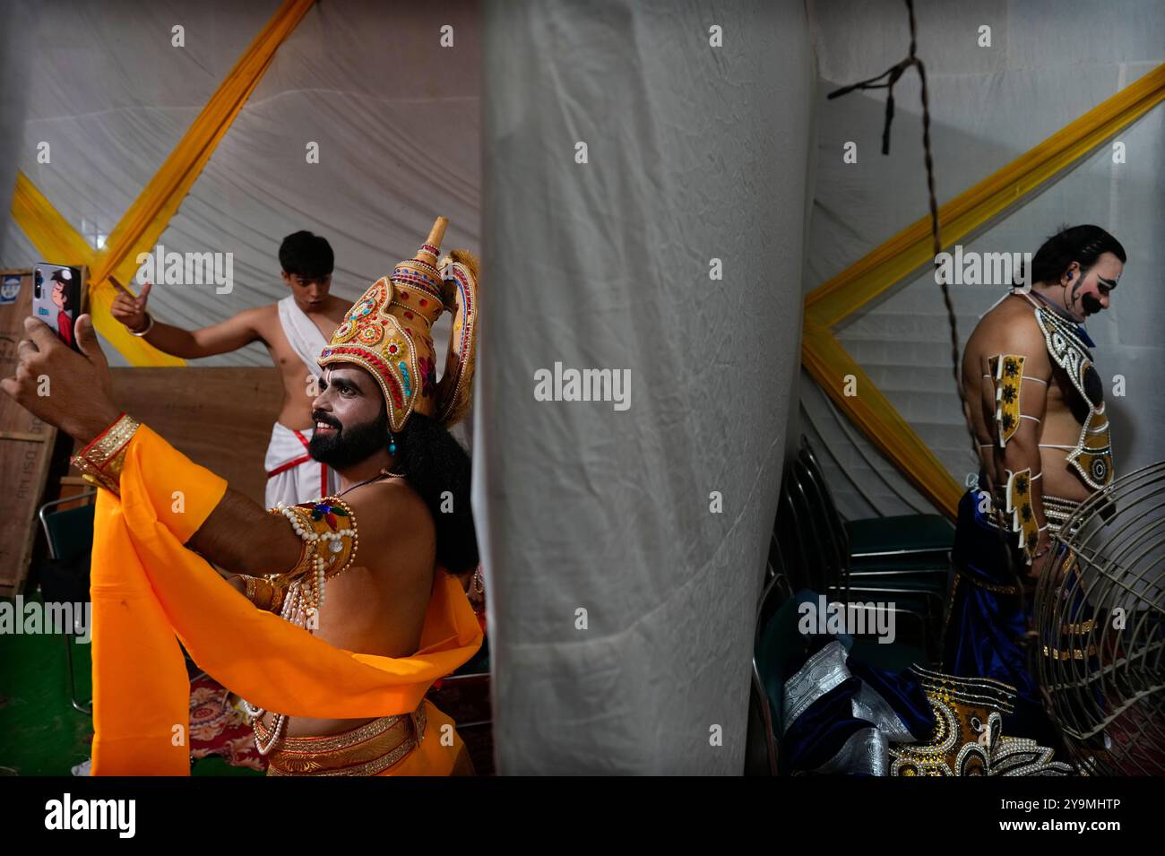 Actors rehearse their lines backstage before the start of Ramleela, a ...