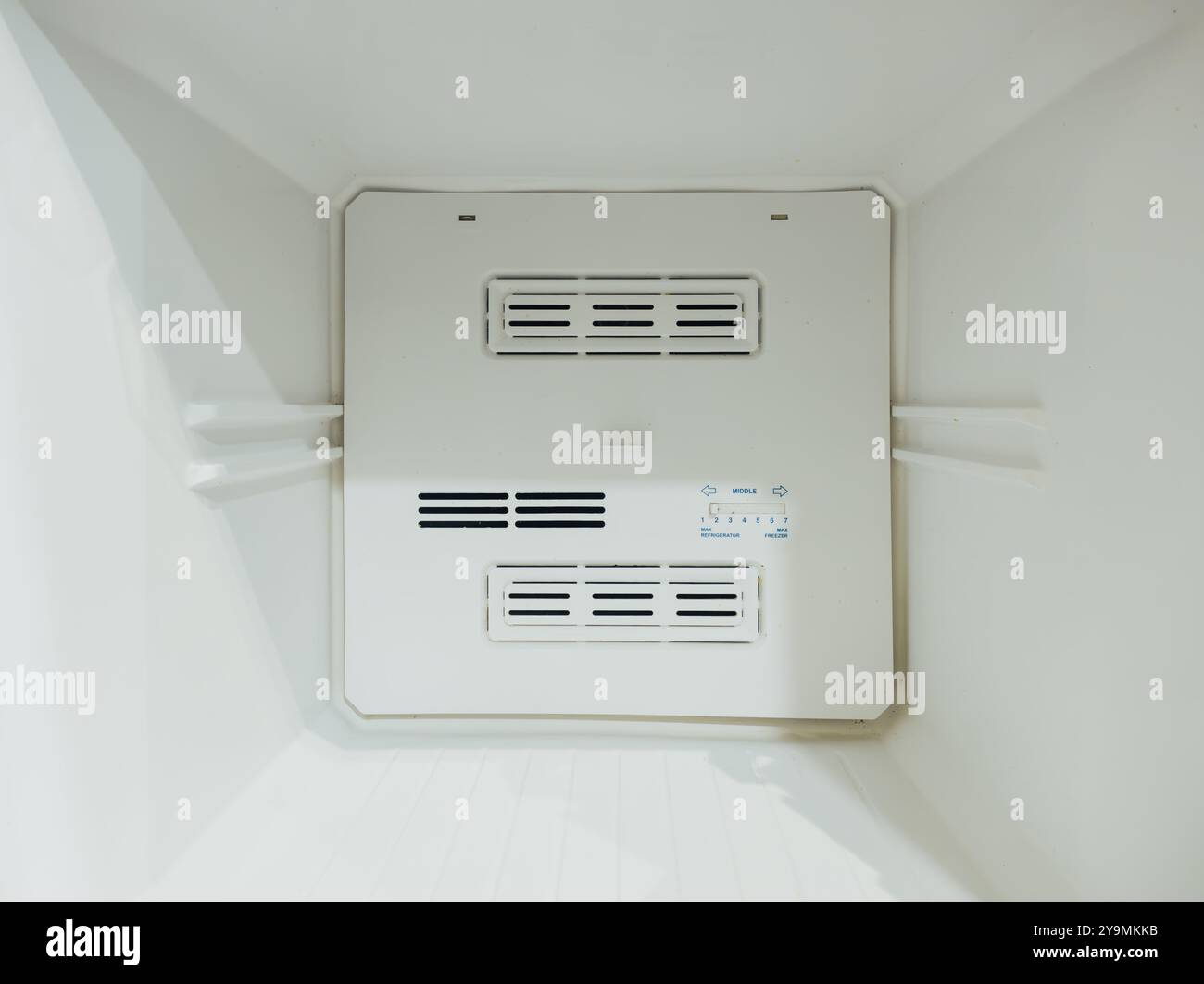 Inside an empty white freezer with manual control panel and vents Stock ...