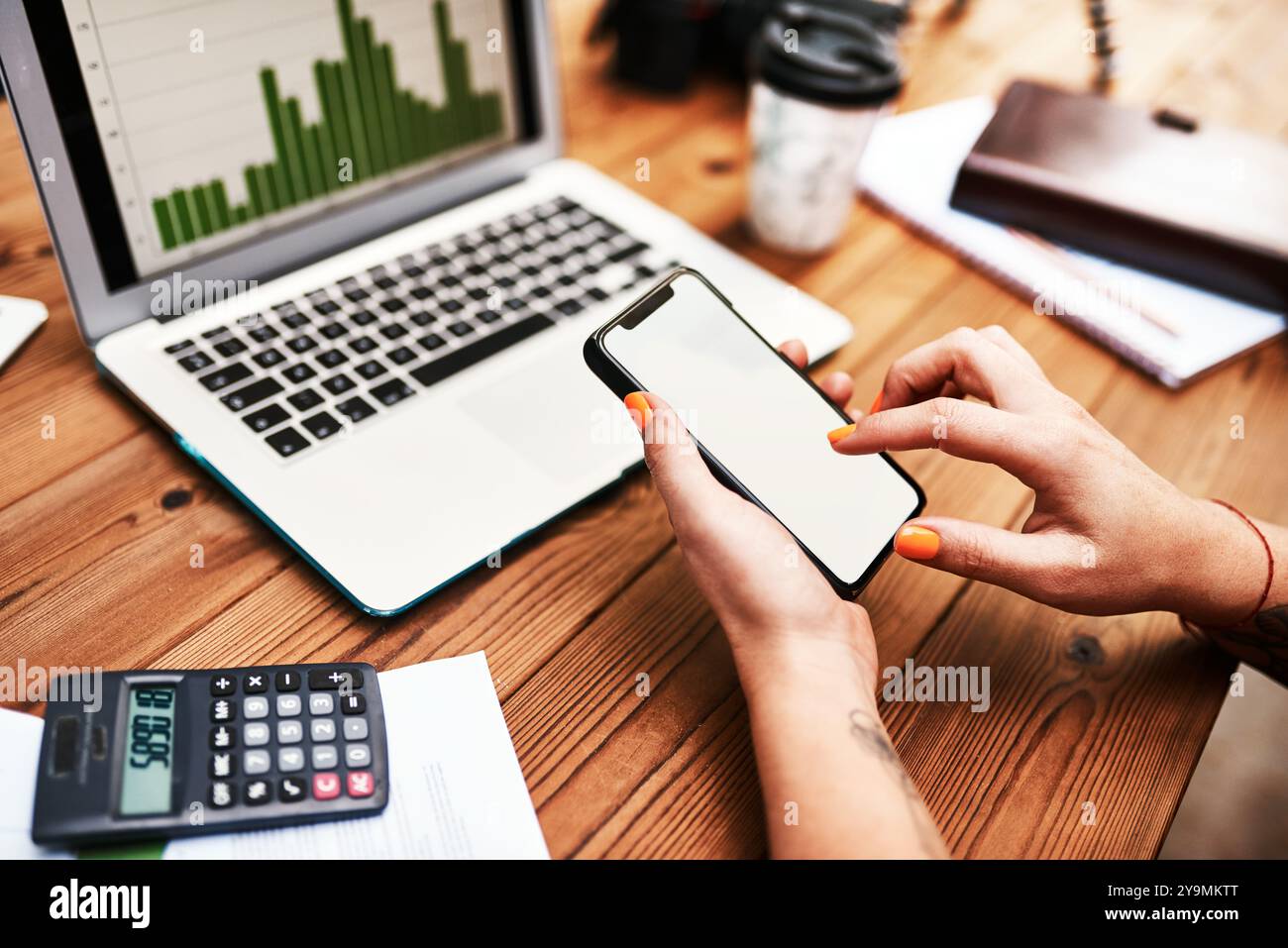 Smartphone, typing and graphs on laptop, hands and planning of budget ...