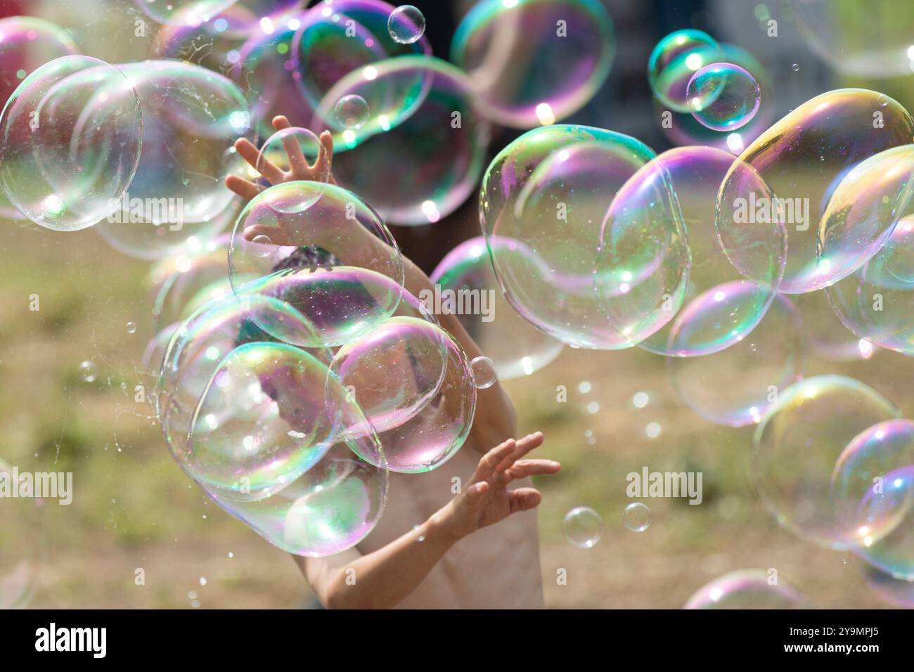 Little Boy Catching Soap Bubbles Stock Photo - Alamy