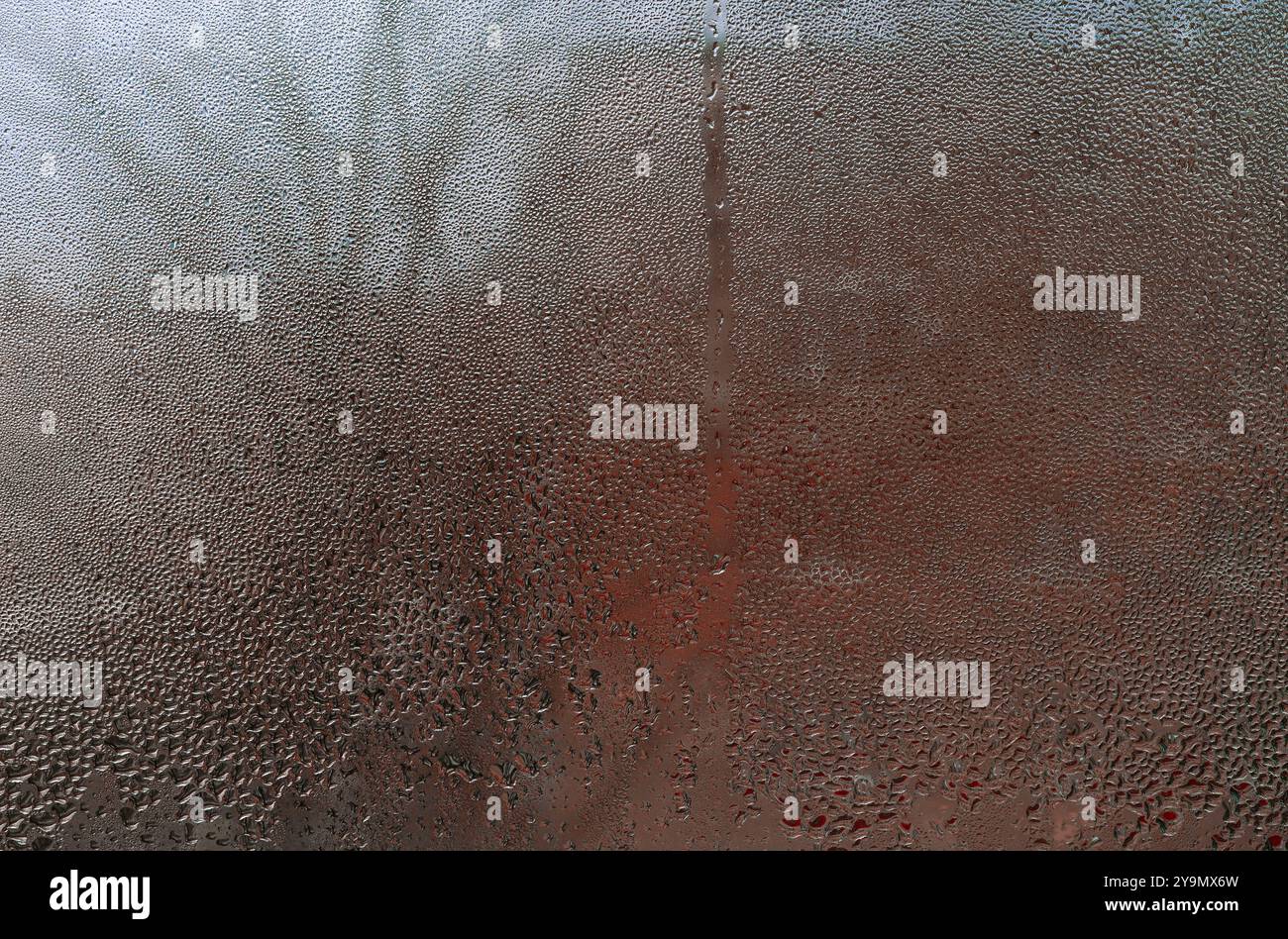 Drops of water run down the surface of the glass. A texture for ...