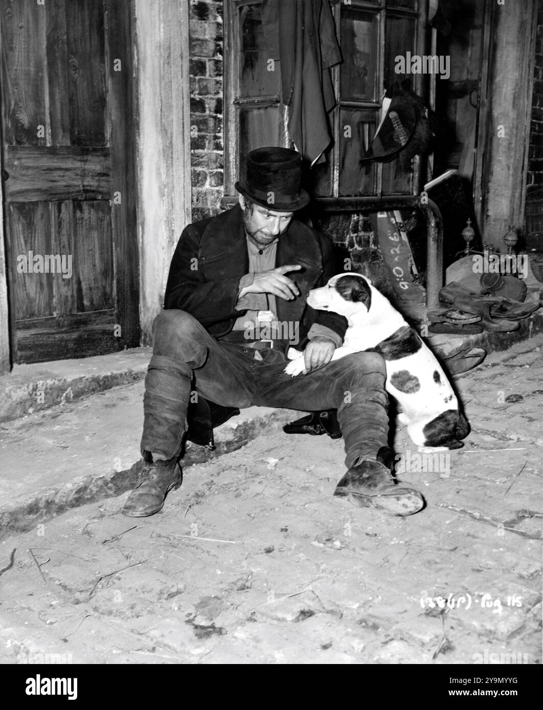 ROBERT NEWTON on set candid portrait as Bill Sikes with his Dog during ...