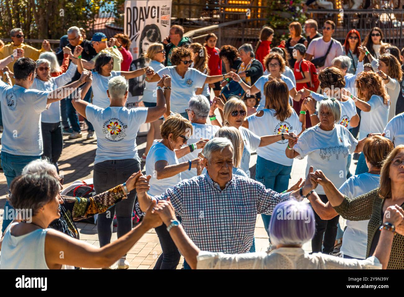 Group of elderly people with their arms raised holding hands dancing ...
