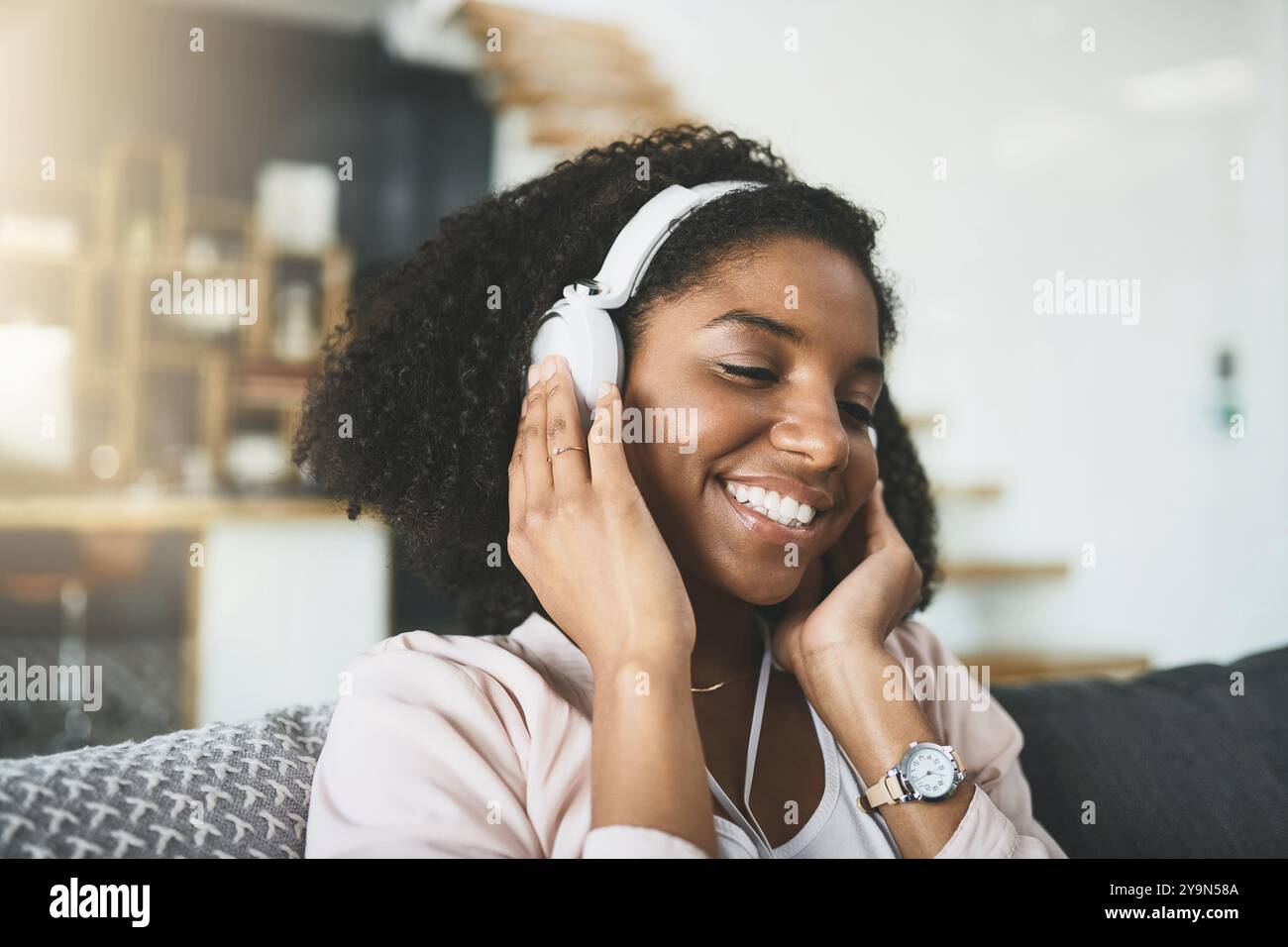House, relax and black woman on couch, headphones and listening to ...