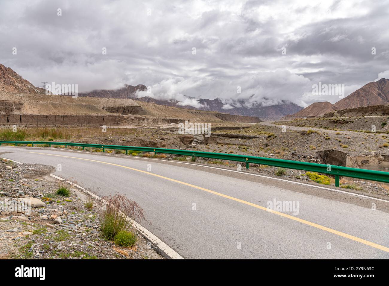 The majestic scenery of Kunlun snow mountains under a cloudy sky ...
