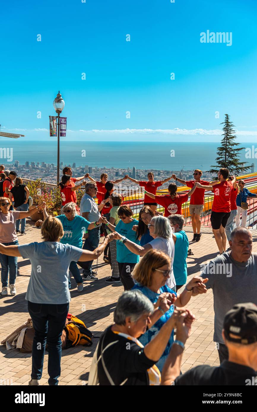 Group of people dancing the Catalan folk dance, the sardana with a view ...
