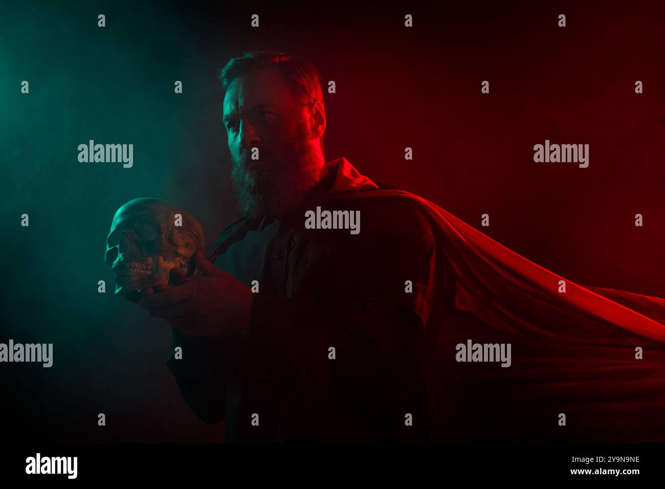 Photo of spooky handsome retired man evil wizard hold human skull ...