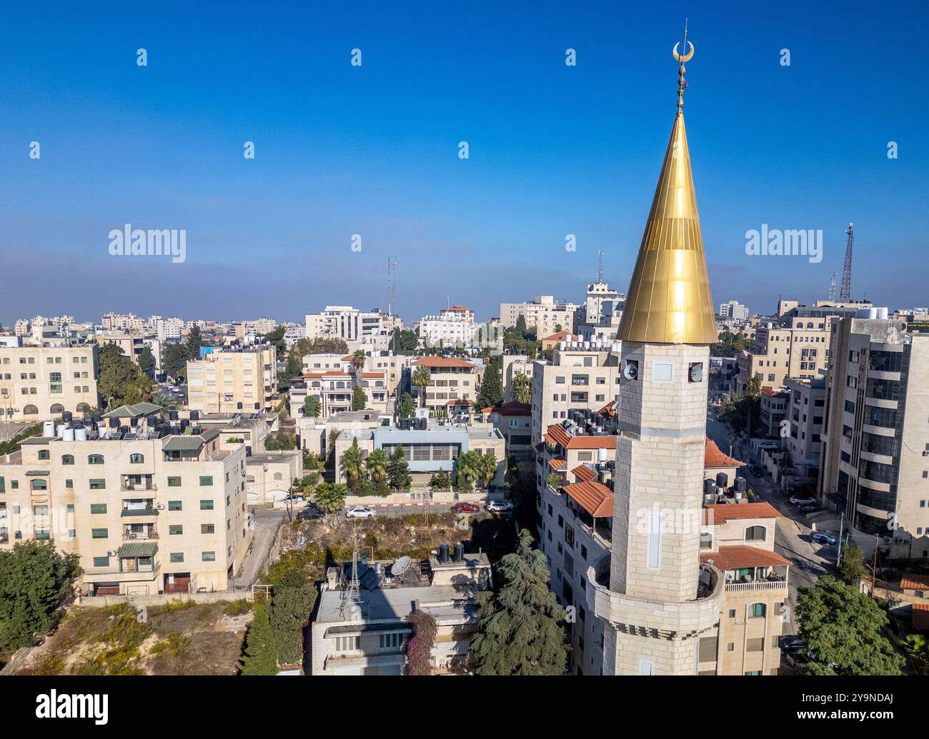 Gold-clad minaret and the skyline of Ramallah, capital of the ...