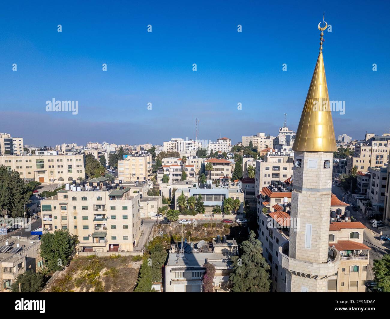 Gold-clad minaret and the skyline of Ramallah, capital of the ...