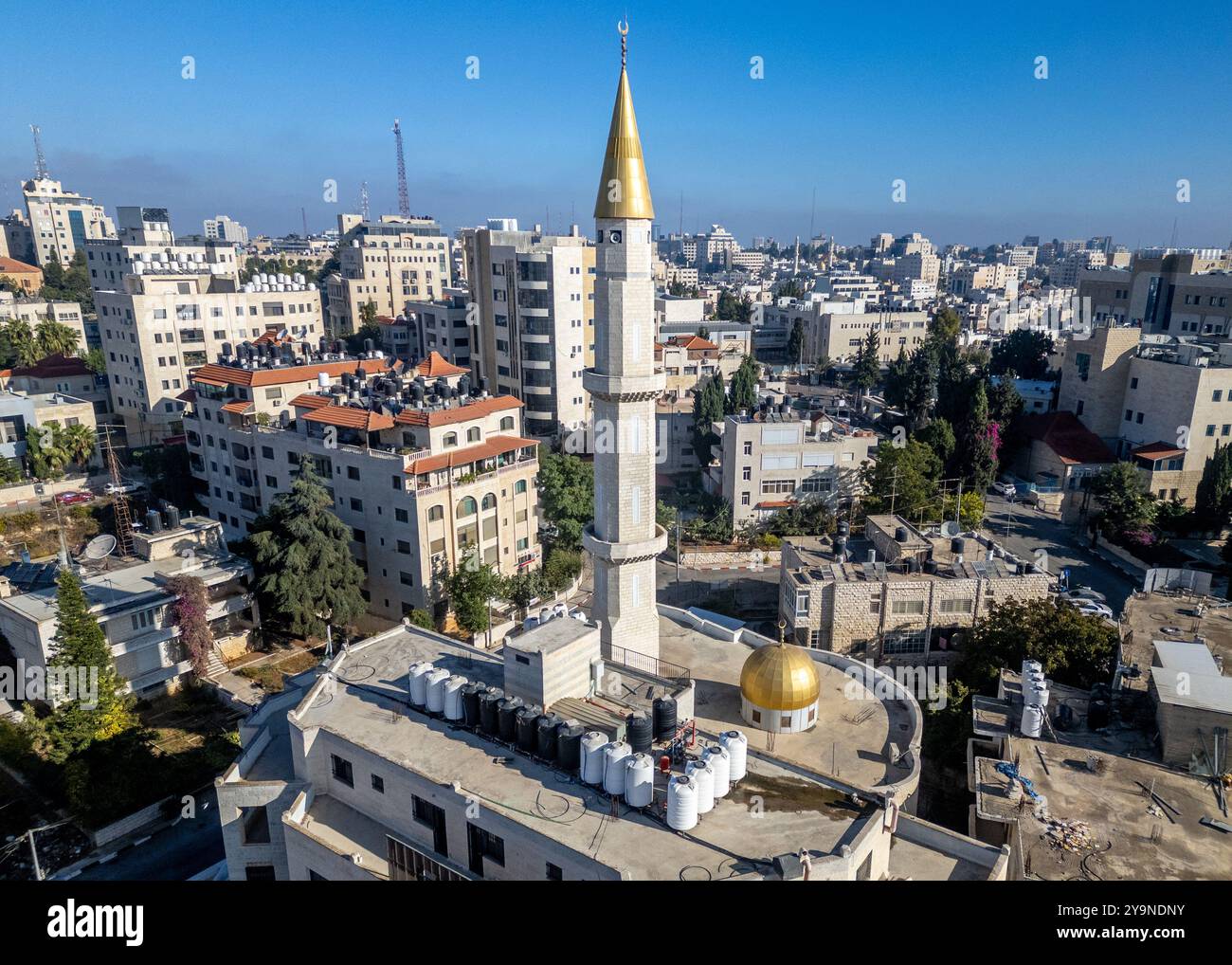Gold-clad minaret and the skyline of Ramallah, capital of the ...
