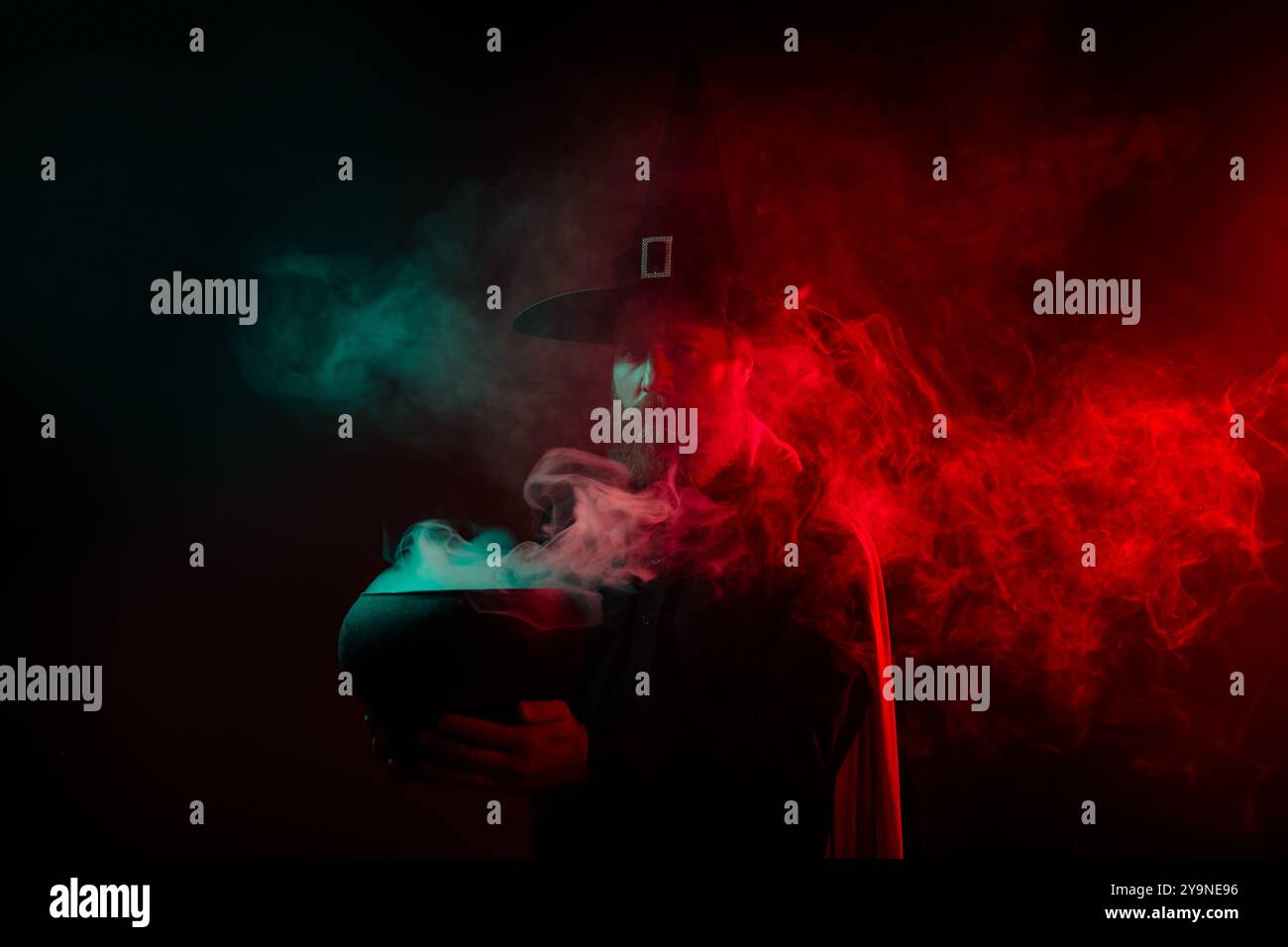 Photo of sorcerer hold cauldron halloween mystery magic ritual isolated ...