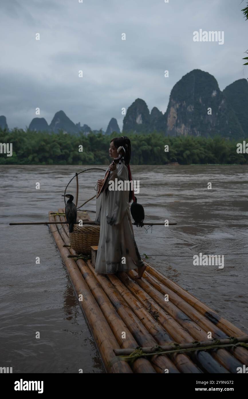 Hanfu girl with pipa instrument posing for a photographer on board of ...